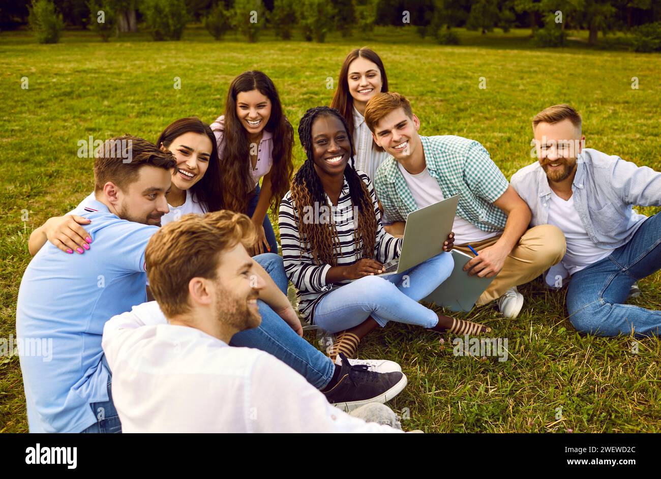 University friends working and studying together using laptop while ...