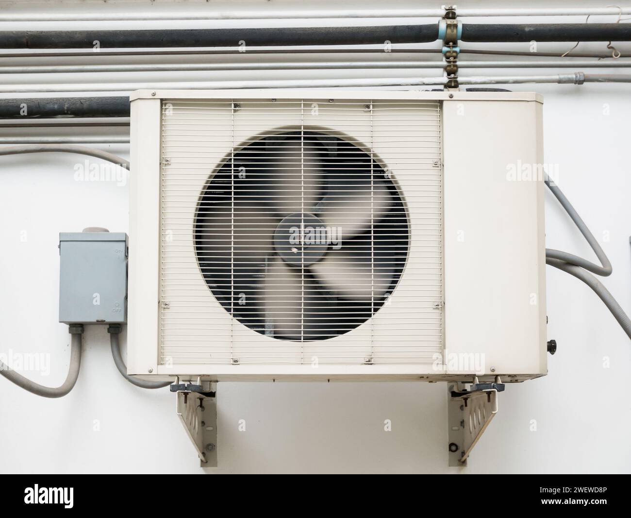 Air conditioner compressor unit installed outdoor in the old building ...