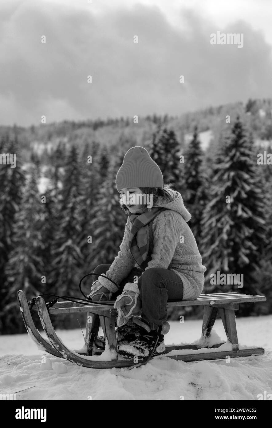 Boy kid enjoying a sleigh ride on winter landscape. Child on sleigh ... Boy kid enjoying a sleigh ride on winter landscape. Child on sleigh ...