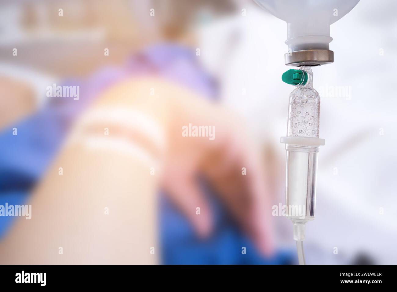 Medical drip with patient in the hospital blurred background Stock ...