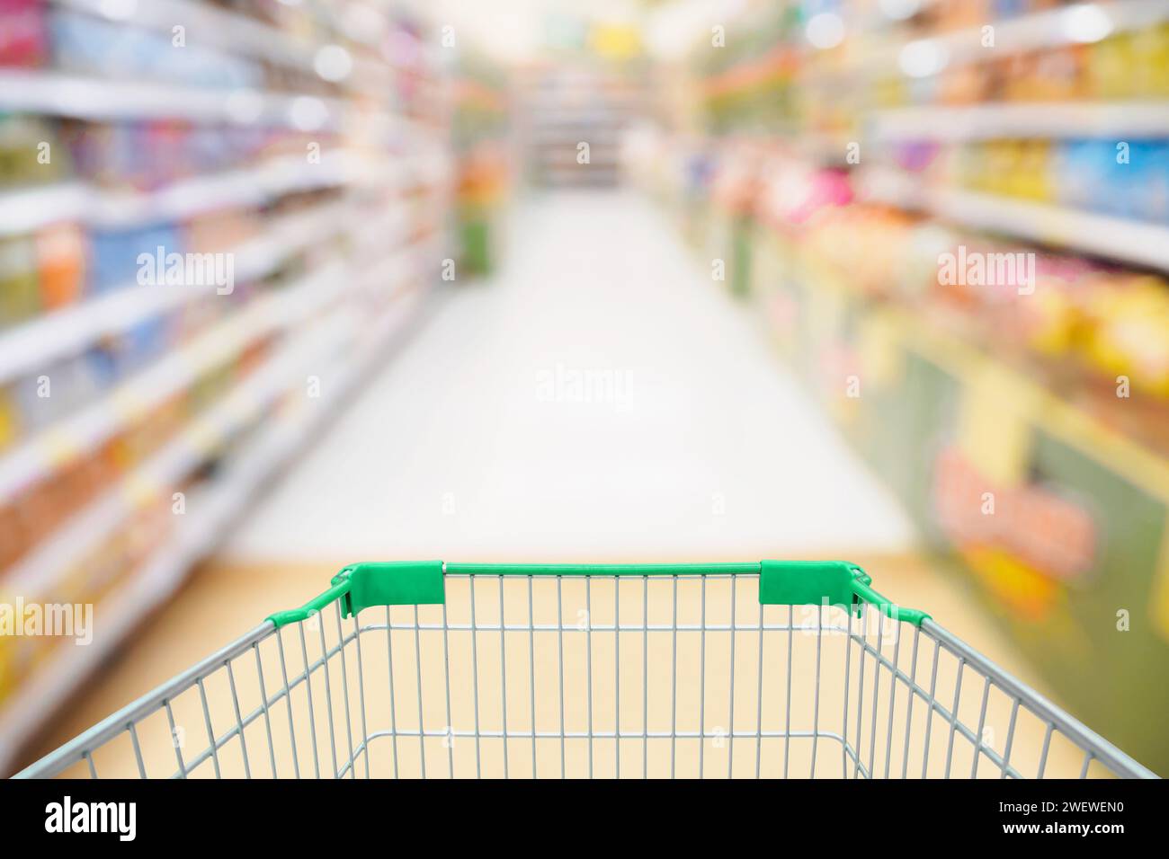 Abstract Supermarket aisle with empty shopping cart Stock Photo - Alamy
