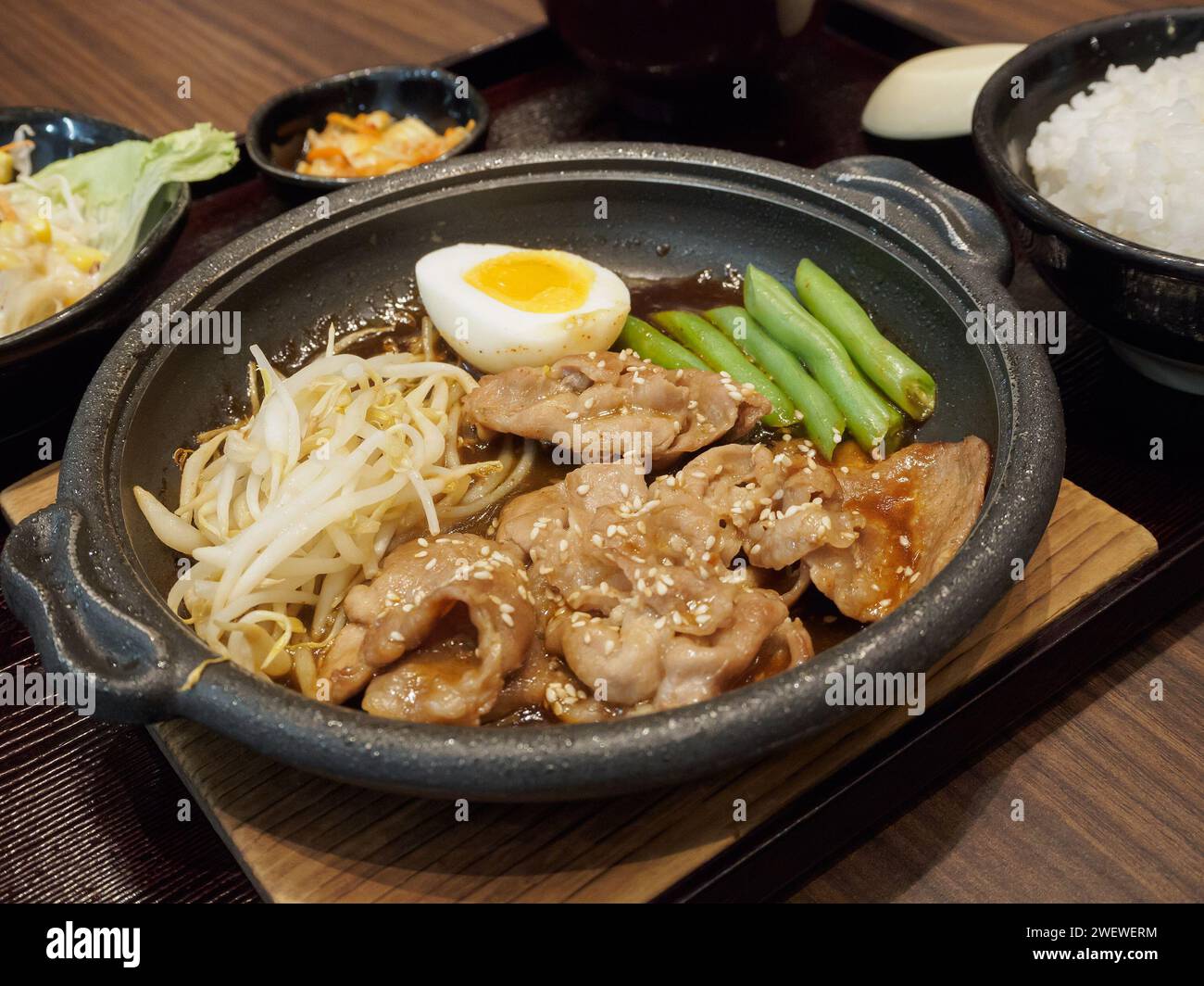 pork teppanyaki with egg and vegetables in hot plate Japanese Cooking ...