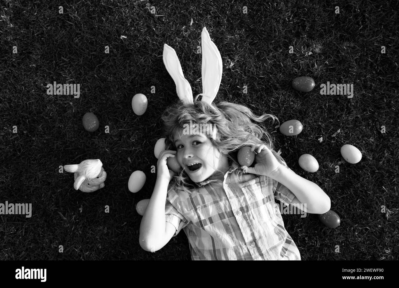 Easter bunny children with rabbit ears in garden hunt egg. Child ...