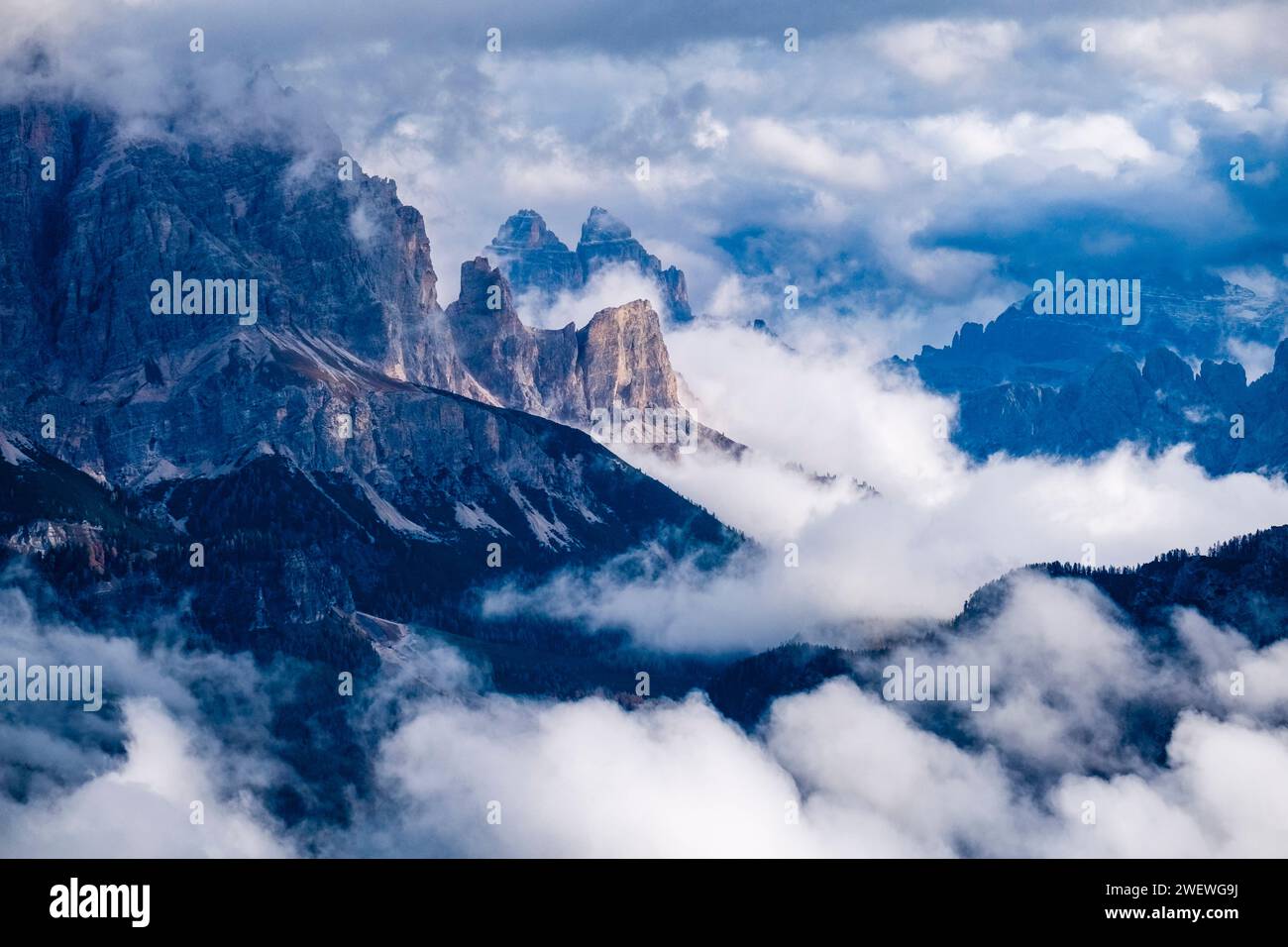 Dolomites mountainscapes with rock formations and moving clouds during ...