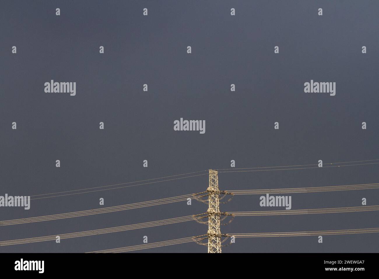 Abstract image of an electricity pylon and high voltage wires against a ...