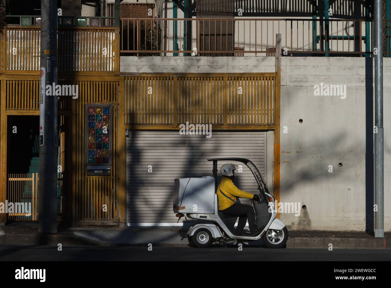 A three-wheeled scooter used for delivery in a street in Machida, Tokyo ...