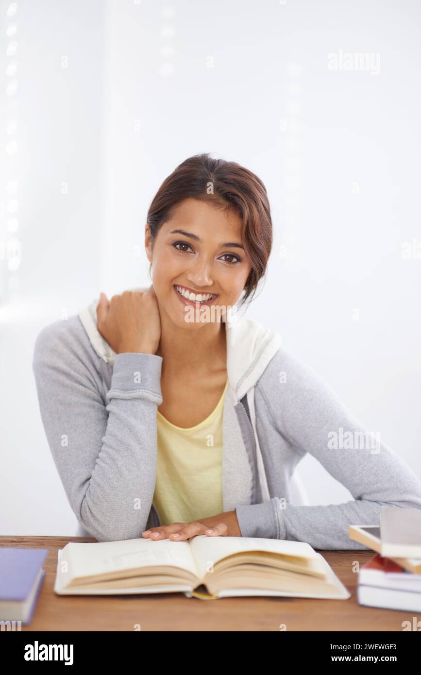Portrait, books or happy woman studying at desk in college, learning ...