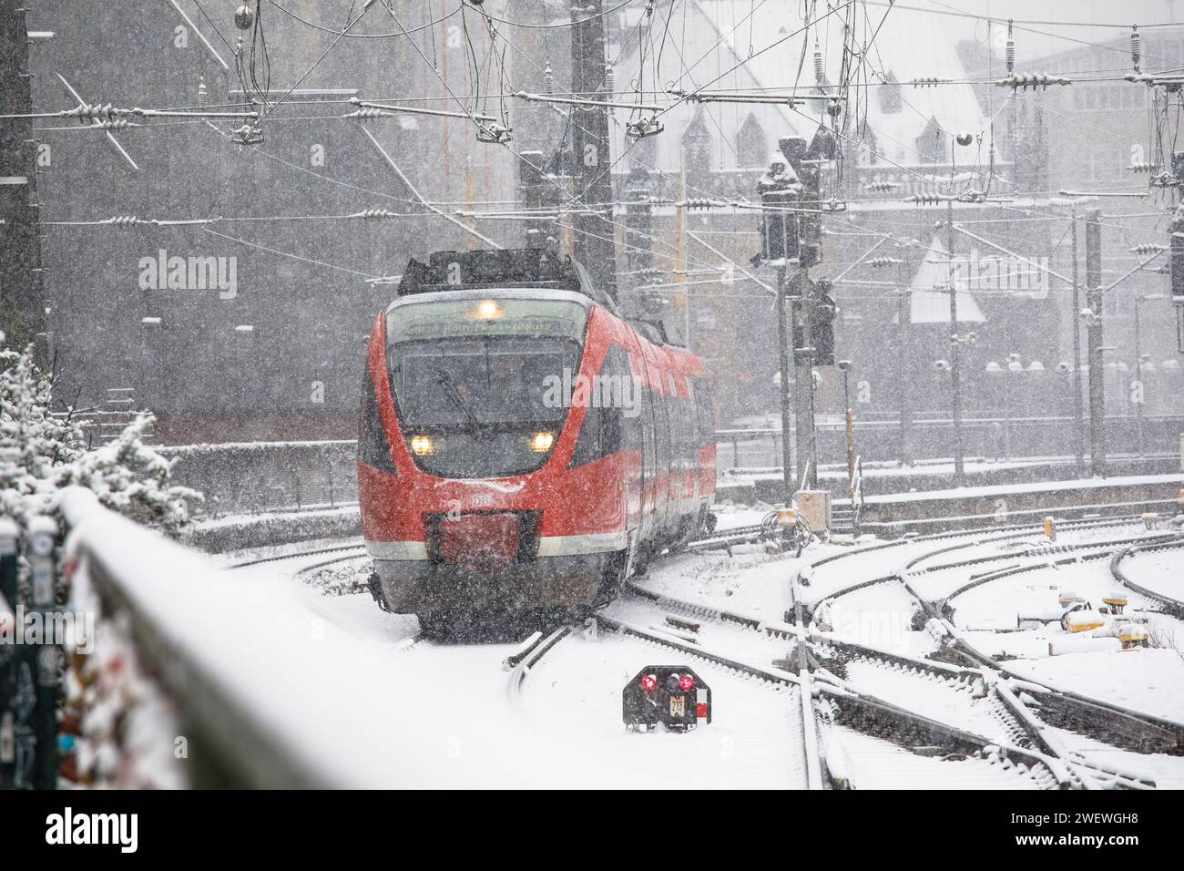 regional train is leaving Cologne central station, snow, snowfall ...