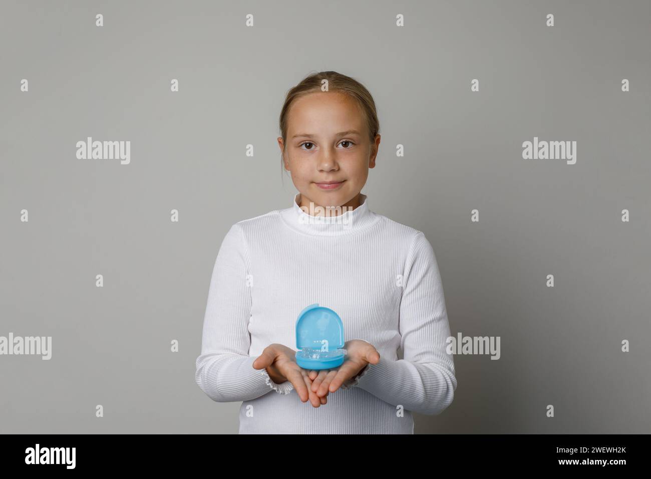 Young pretty child girl showing correction of children occlusion by pre ...