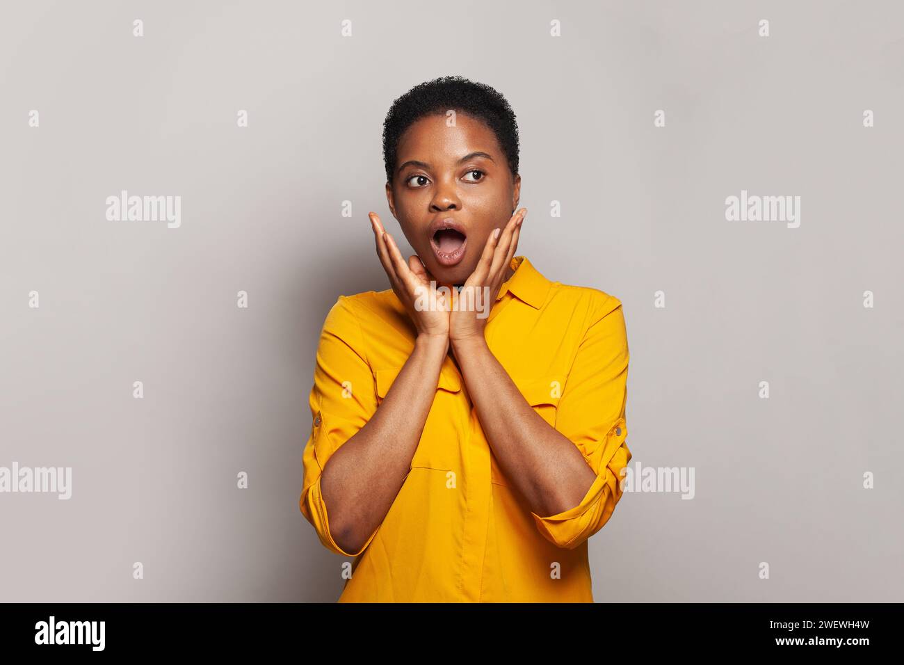 Attractive shocked woman. Young emotional model, studio portrait ...