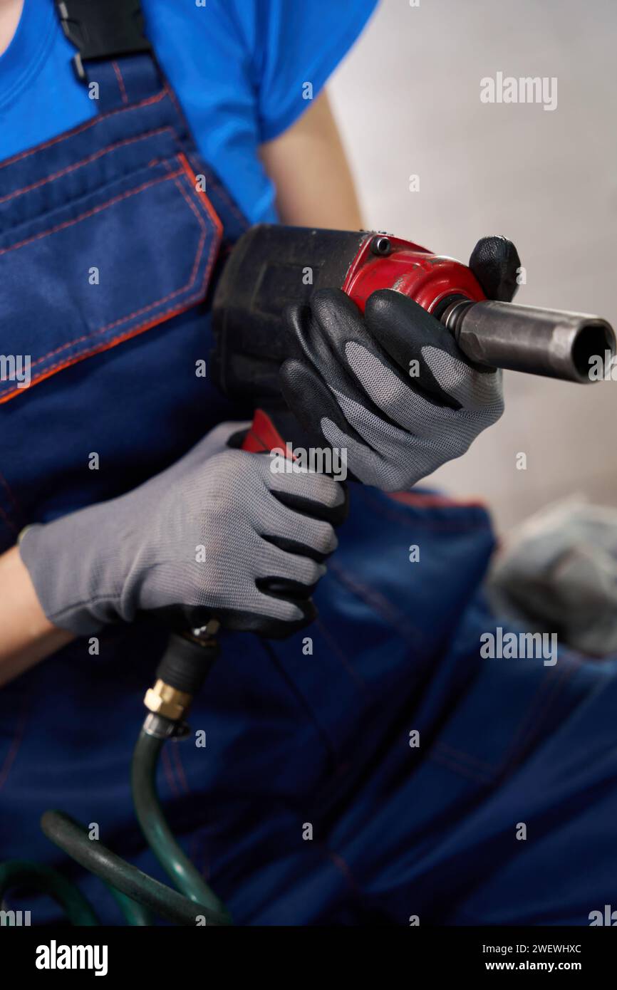 Mechanic uses pneumatic tool hi-res stock photography and images - Alamy