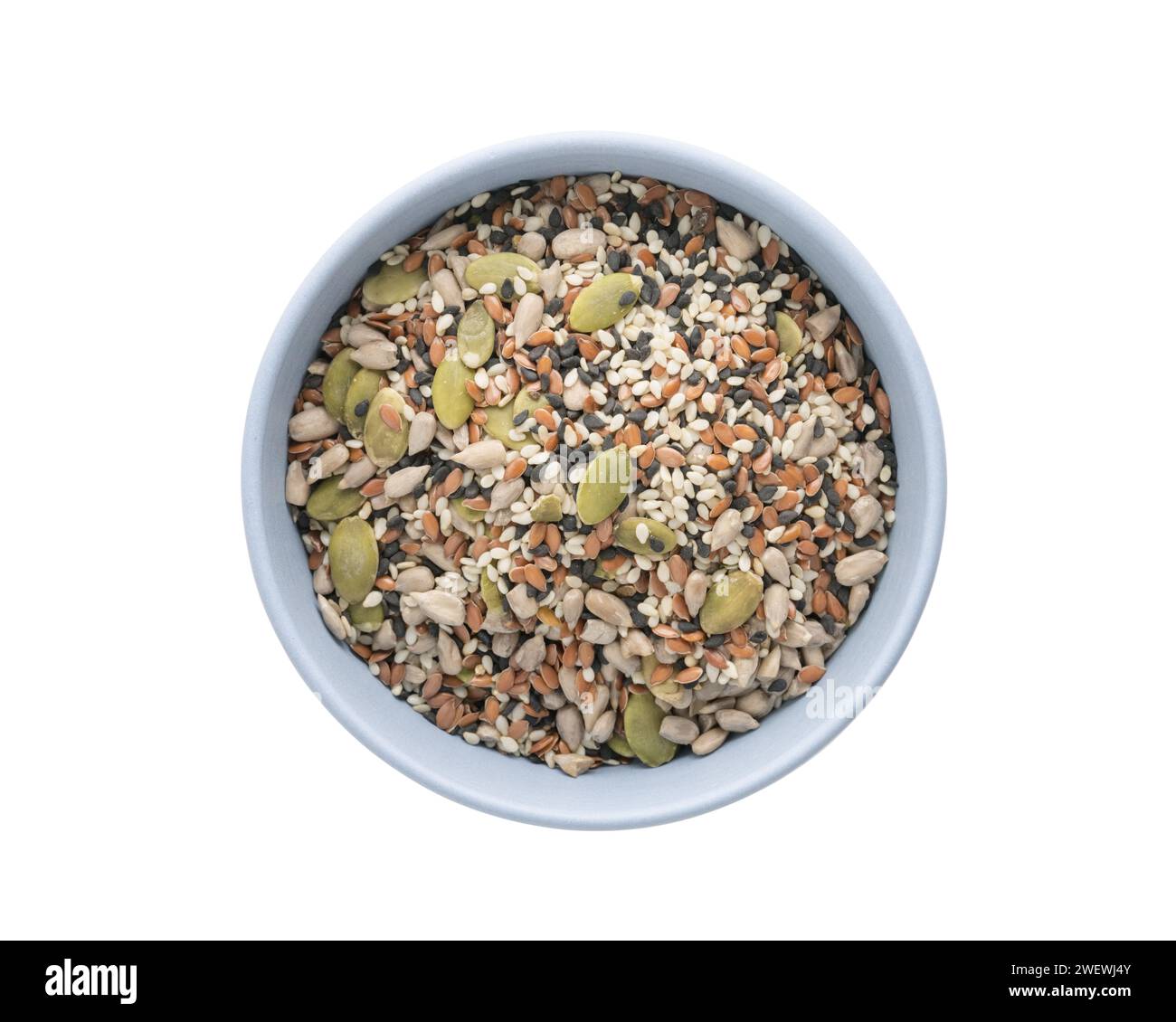 Top view of seed mix for salad in blue bowl isolated on white ...