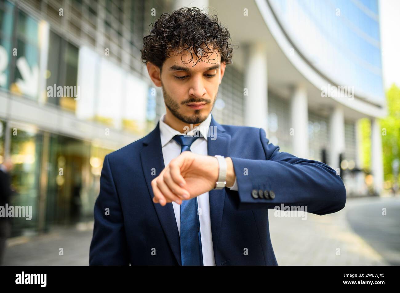 Businessman watching the time in a modern city Stock Photo - Alamy