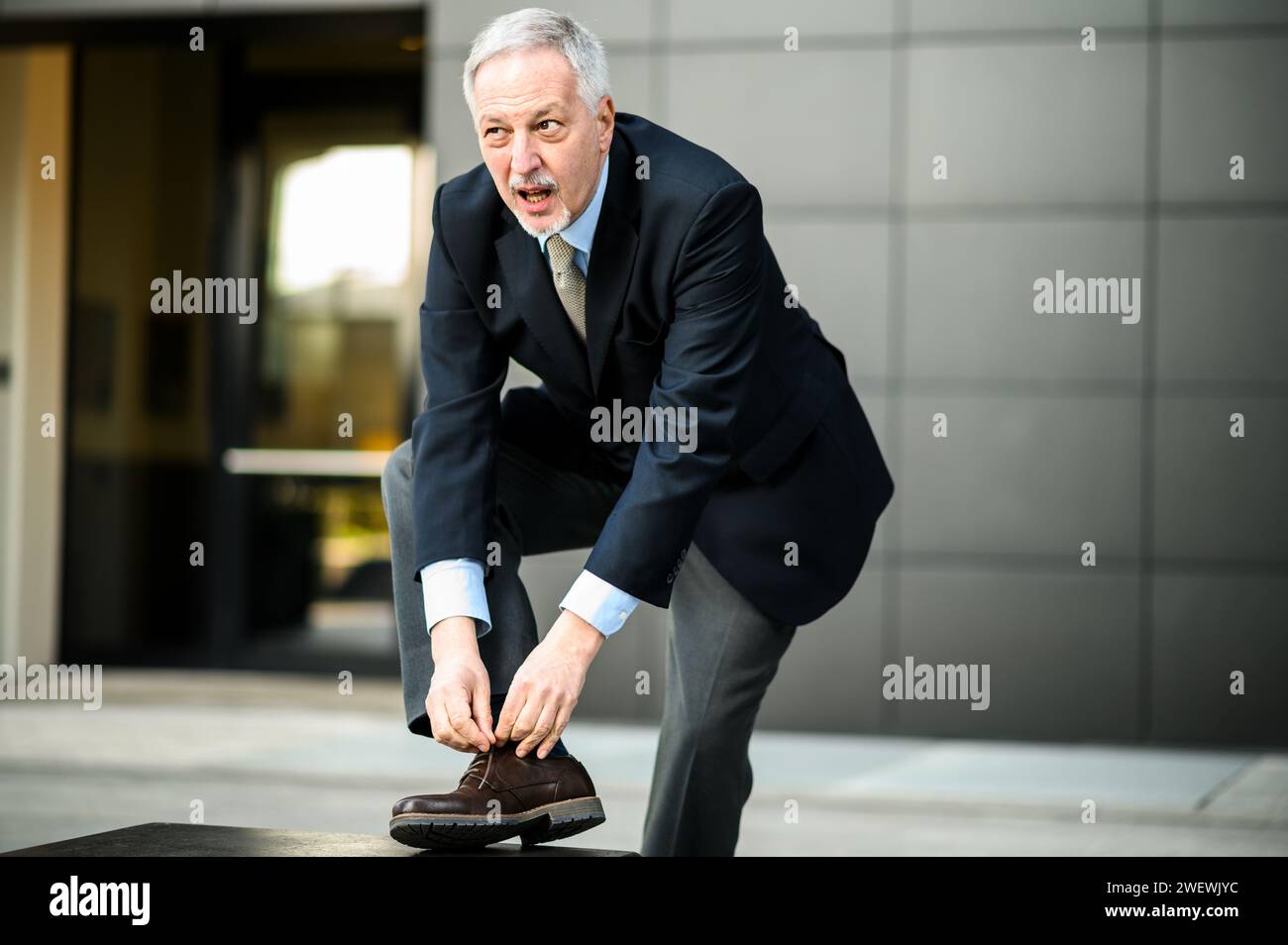 Businessman tying shoes hi-res stock photography and images - Alamy