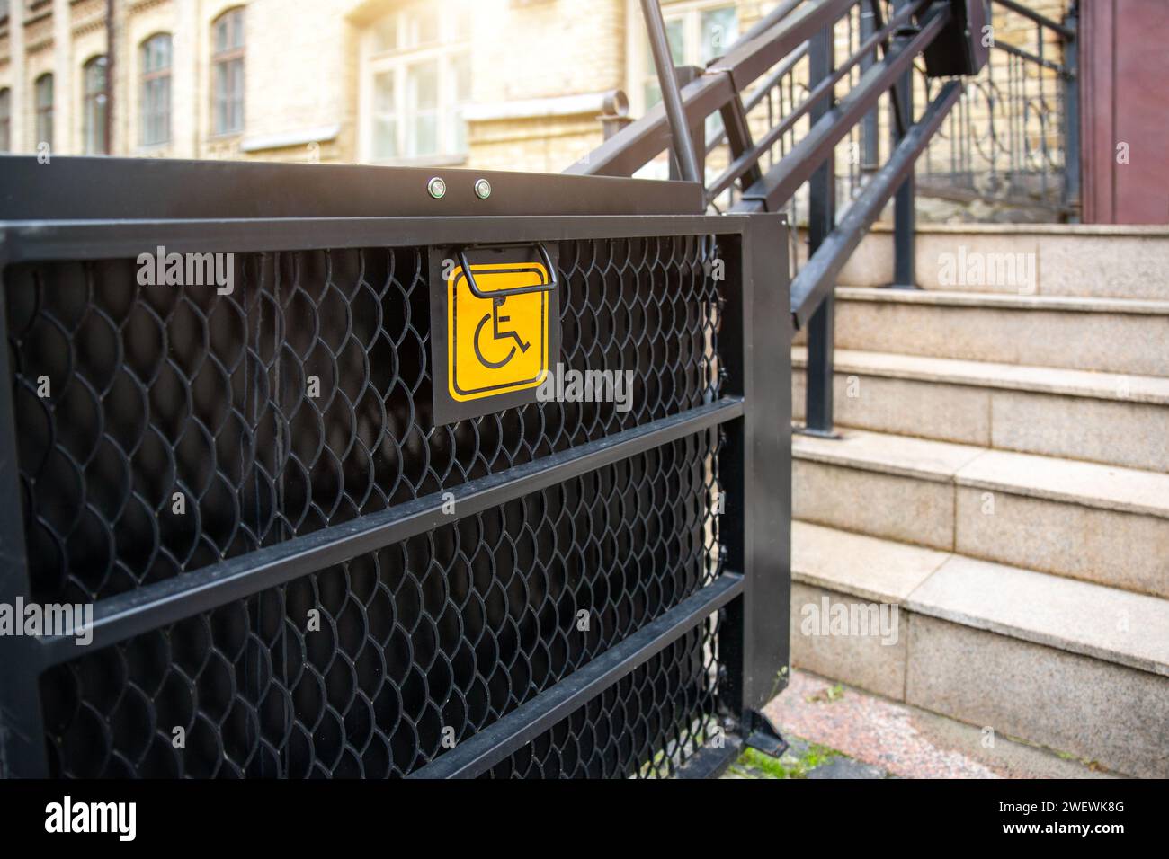 Electric platform lift at building staircase for disabled people with ...