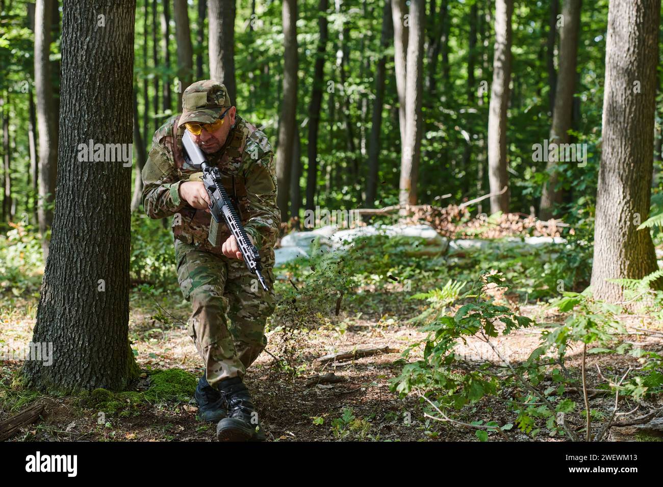 An elite soldier, camouflaged and stealthily navigating through ...