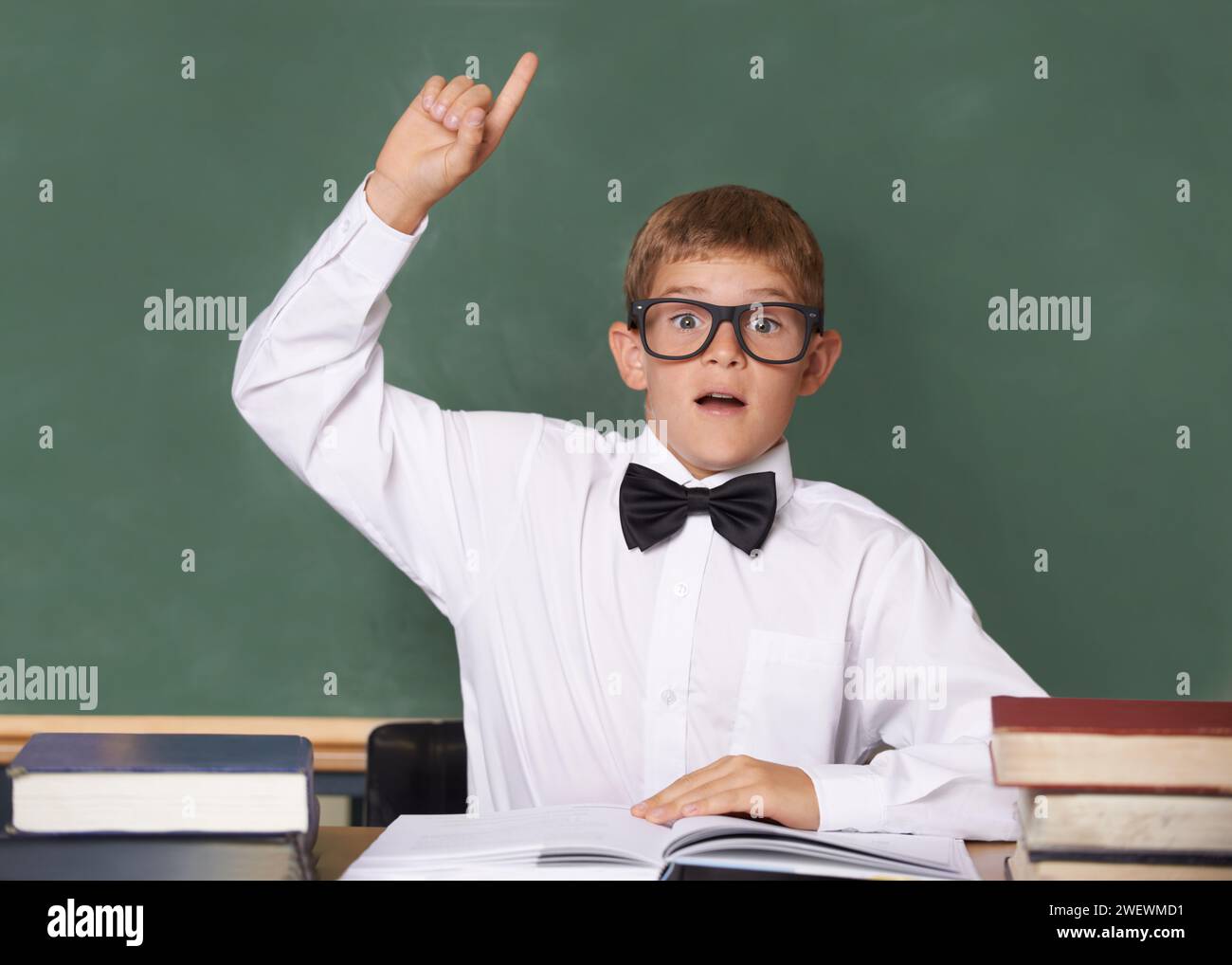 Young boy, portrait and question at school for learning, education or ...