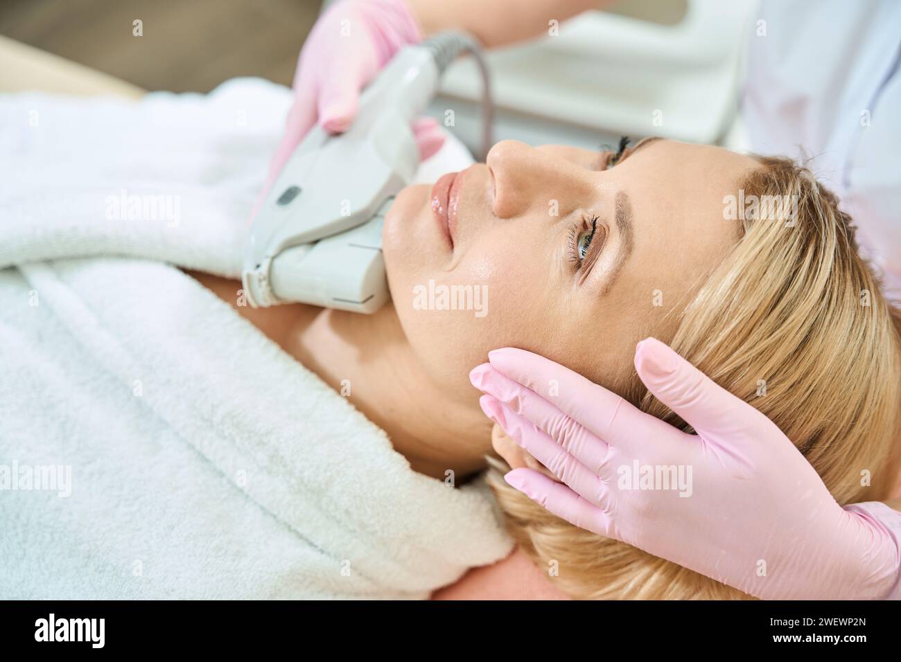 Partial female beautician doing laser depilation with laser hair ...