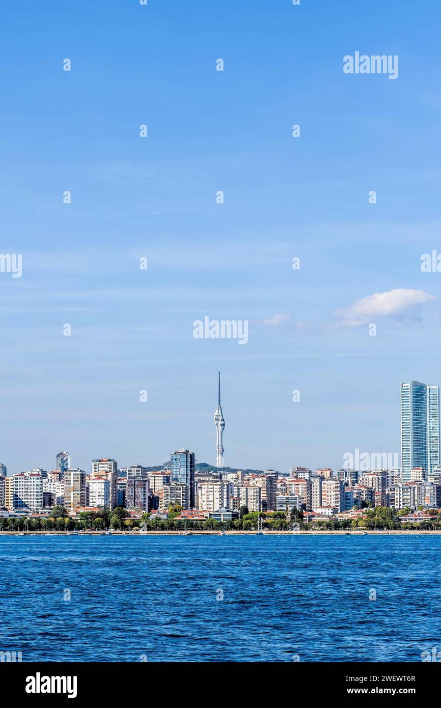 Coastal landscape of city buildings with communication tower in ...