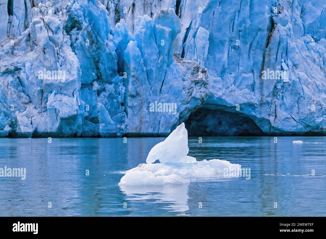 Ice floe floating in the sea at a glacier with a cave in the arctic ...