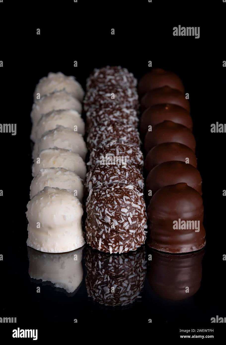 Row of chocolate kisses covered with dark and light chocolate, grated ...