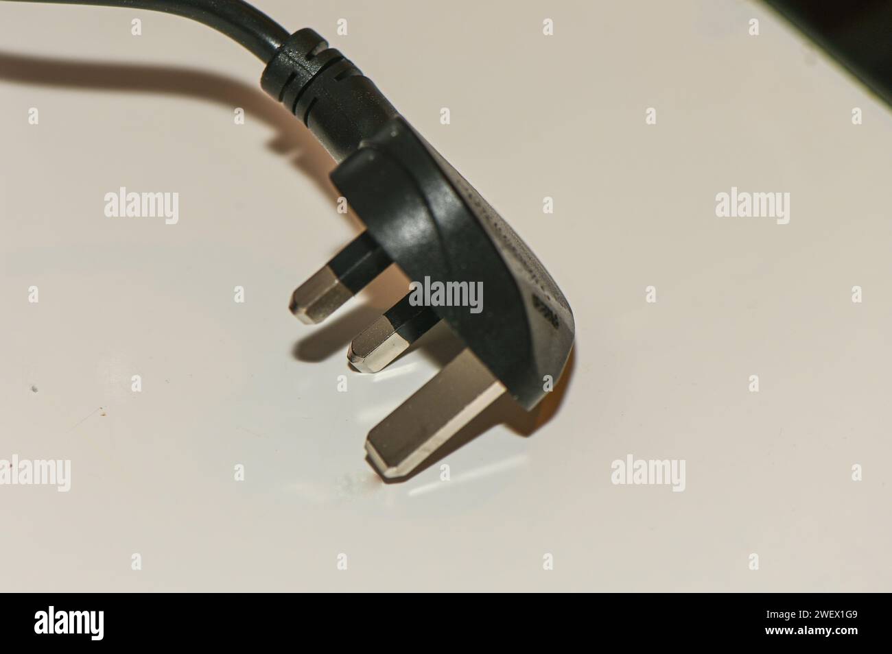 black plug from English standard socket on the table 2 Stock Photo - Alamy