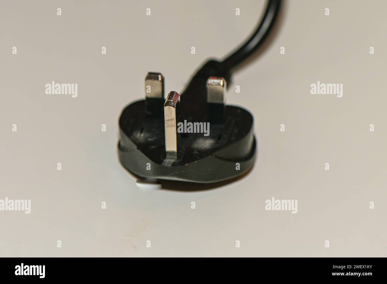 black plug from English standard socket on the table Stock Photo - Alamy