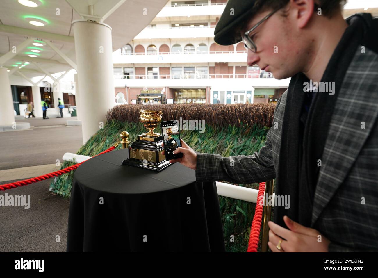 A racegoer takes a picture of the Cheltenham Gold Cup trophy during the ...