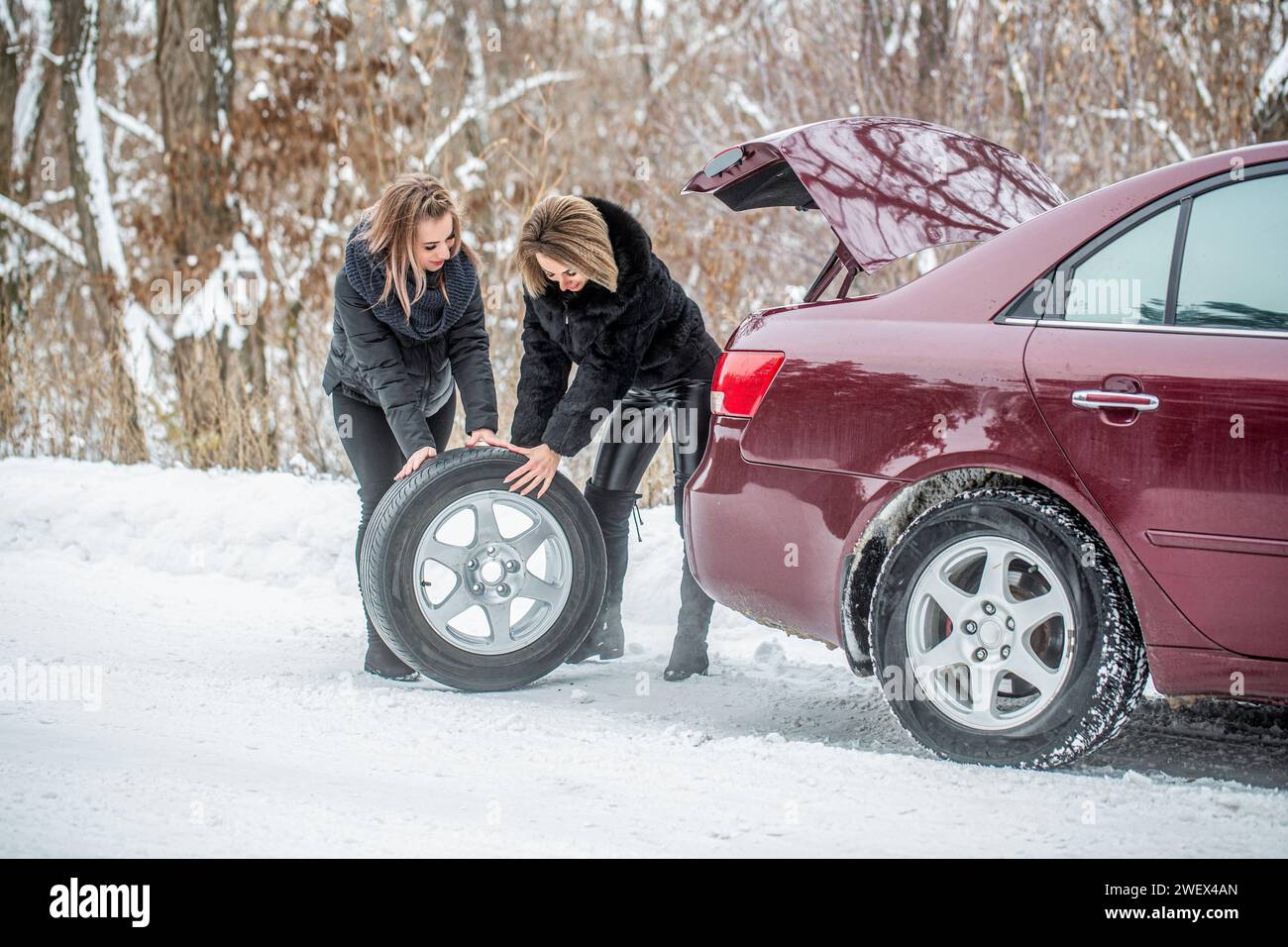 Girls trying to repair the car, engine repair, tire change. Female ...