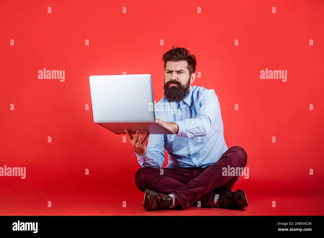 Serious bearded man worker laptop. Man worker laptop. Beard man sitting ...