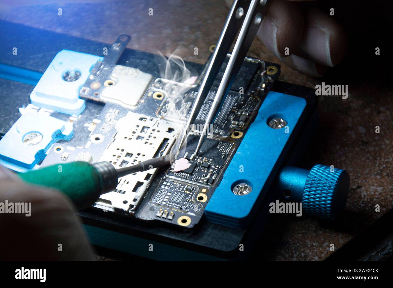 Top view, mechanic doing repairs Smartphone motherboard, smartphone ...