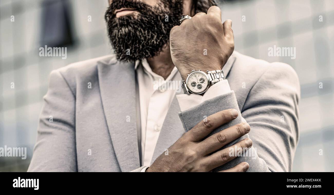 Man holds his watch. Portrait successful businessman in a business suit ...