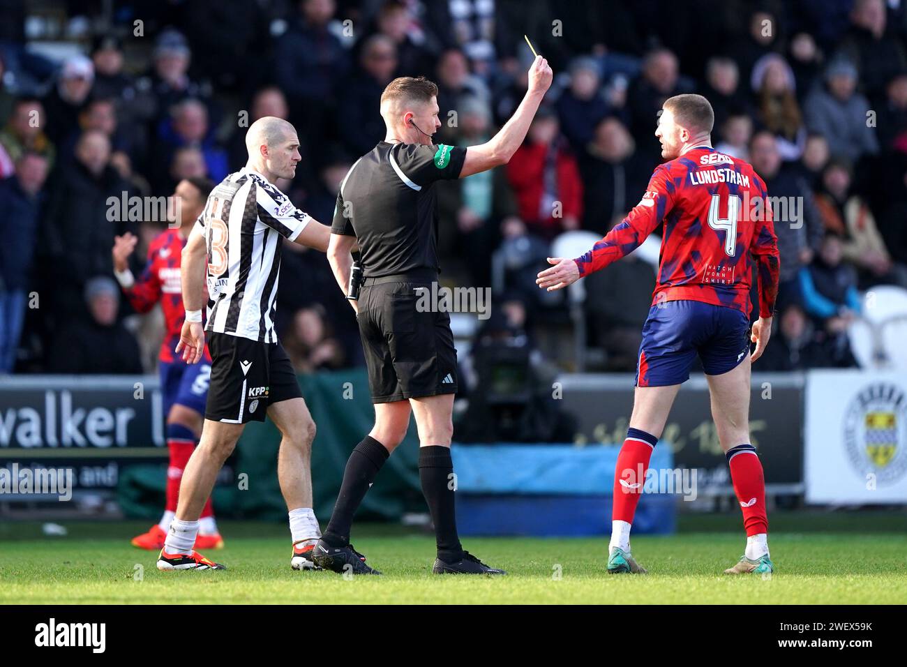 Referee David Dickinson (centre) shows a yellow card to Rangers' John ...