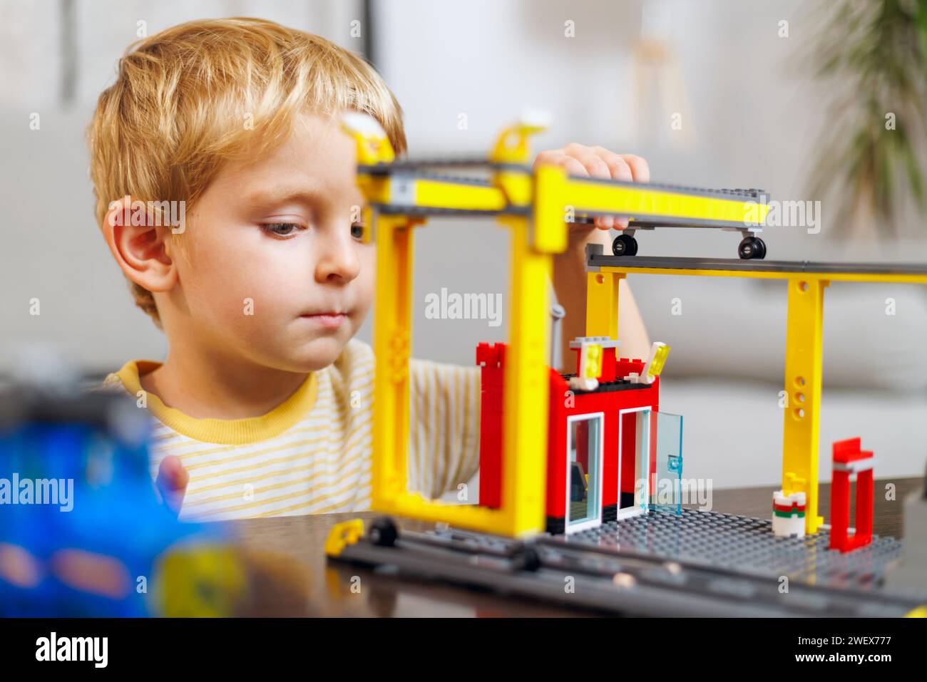 Young Boy Concentrated on Building Toy Construction Stock Photo - Alamy
