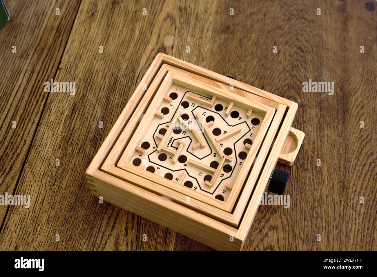 Labyrinth, wooden puzzle maze game and toy. Try to tilt the playfield ...