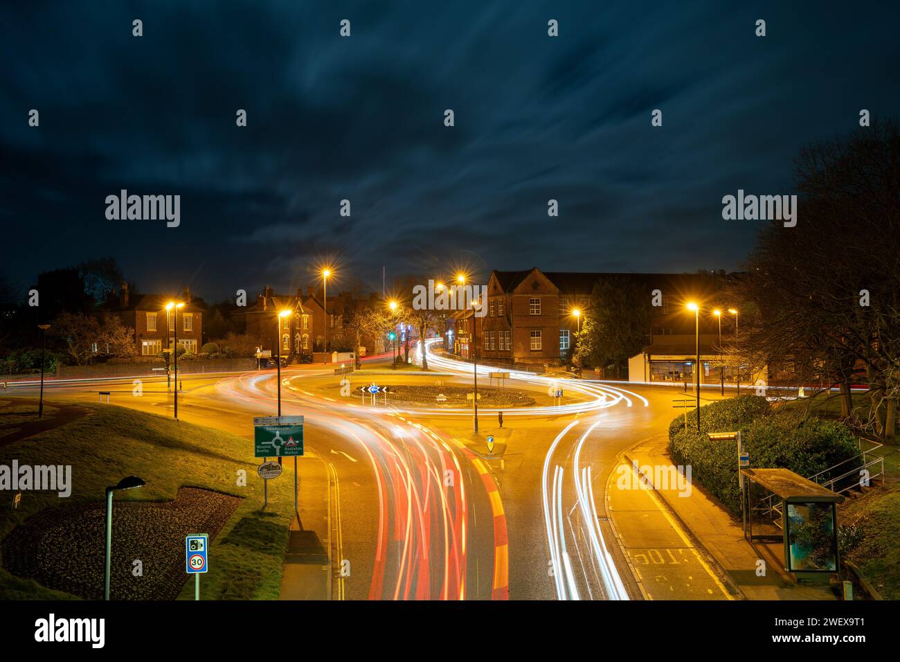 Night view of a busy small roundabout in a town Stock Photo - Alamy