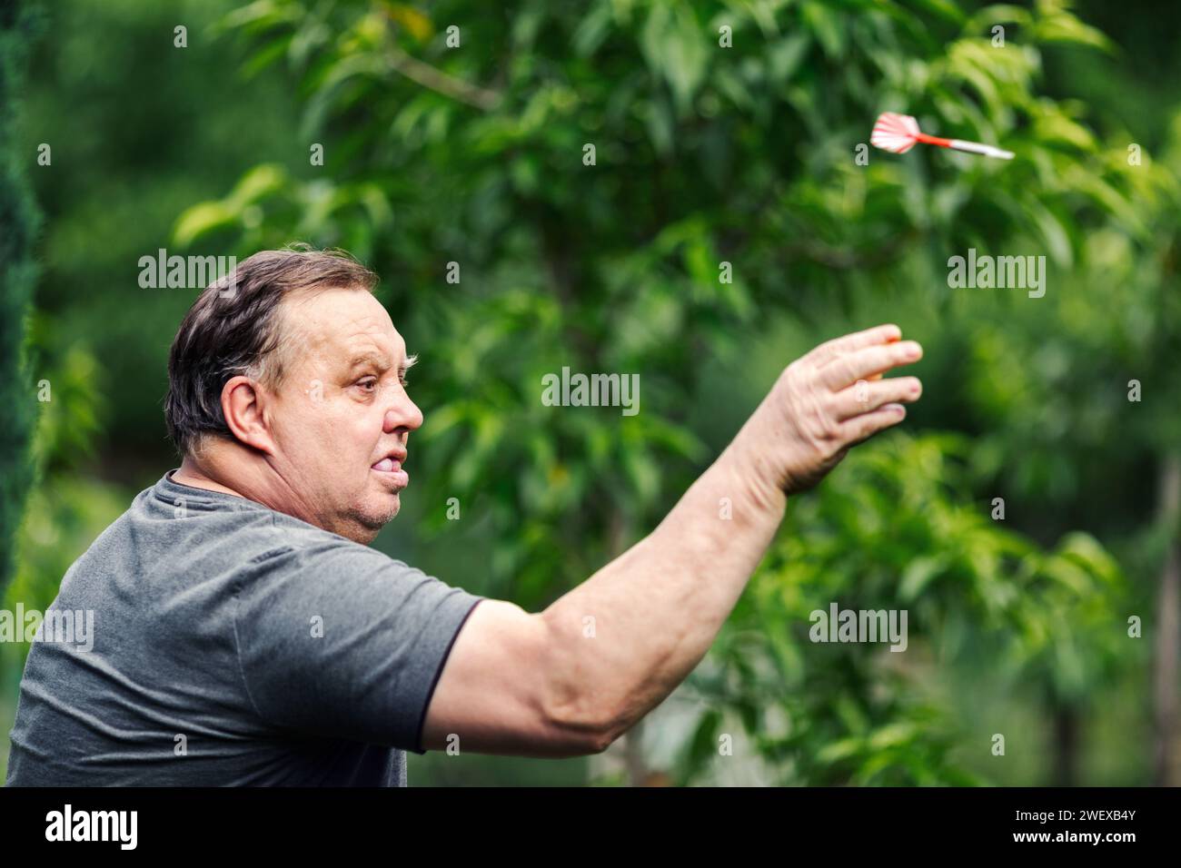 Man playing a game of darts. He needs concentration and perfection to ...