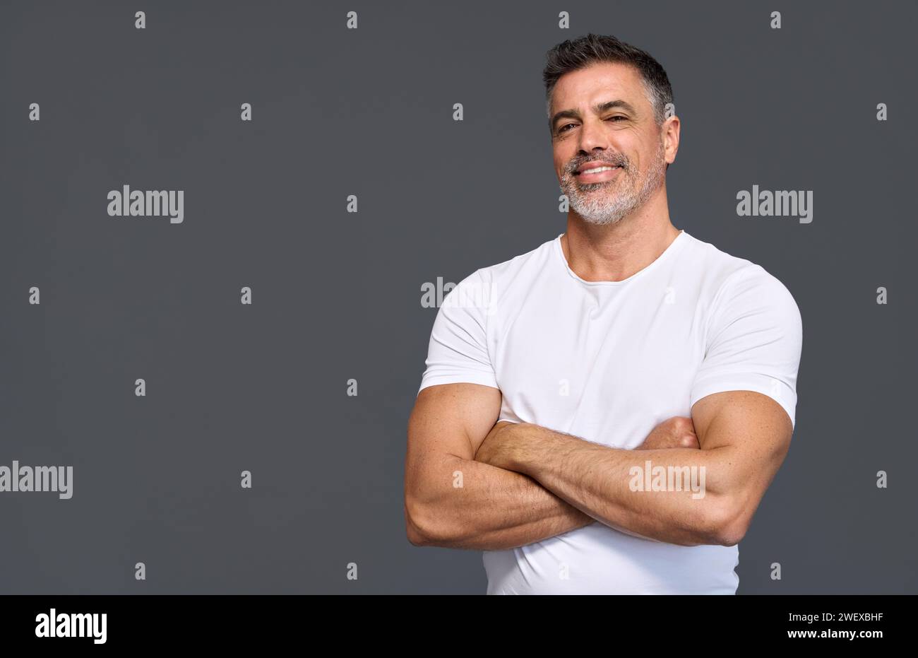 Happy fit sporty older man personal trainer isolated on gray, portrait ...