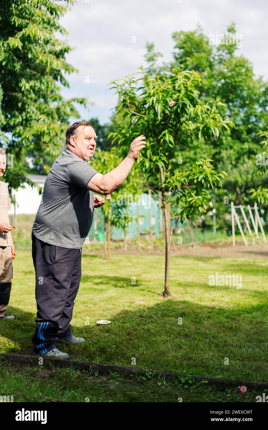Man playing a game of darts. He needs concentration and perfection to ...