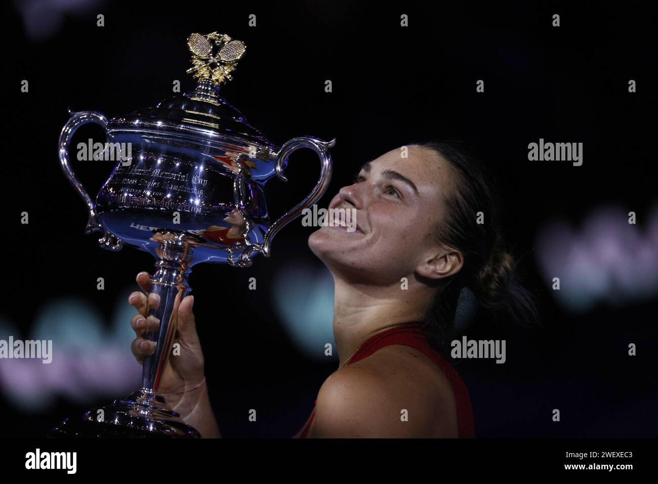 Aryna Sabalenka lifts the trophy after won the finals against Qinwen Zheng (CHN) on day 14 of ...