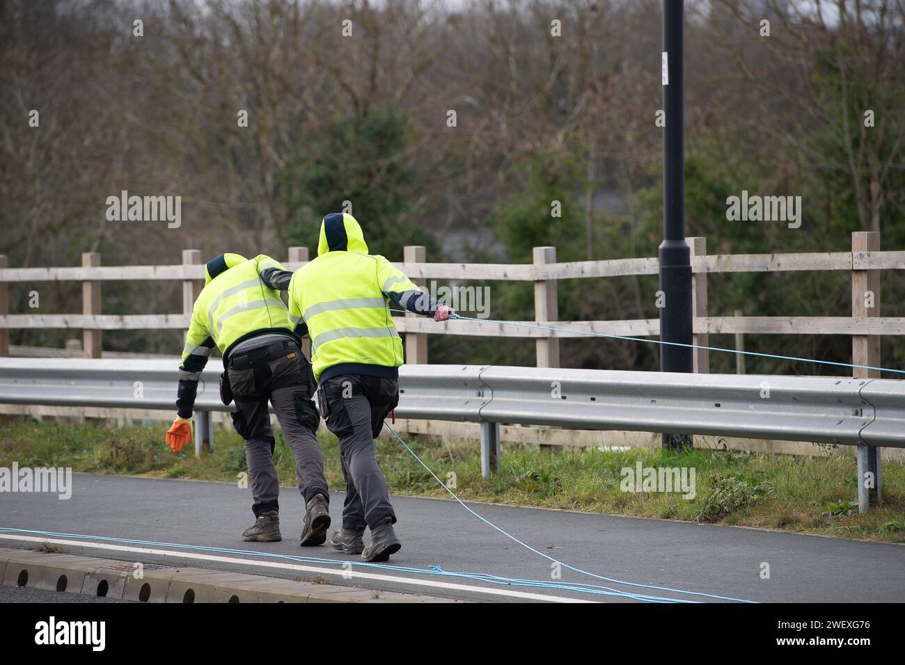 Datchet, UK. 25th January, 2024. Contractors pulling comms cabling ...