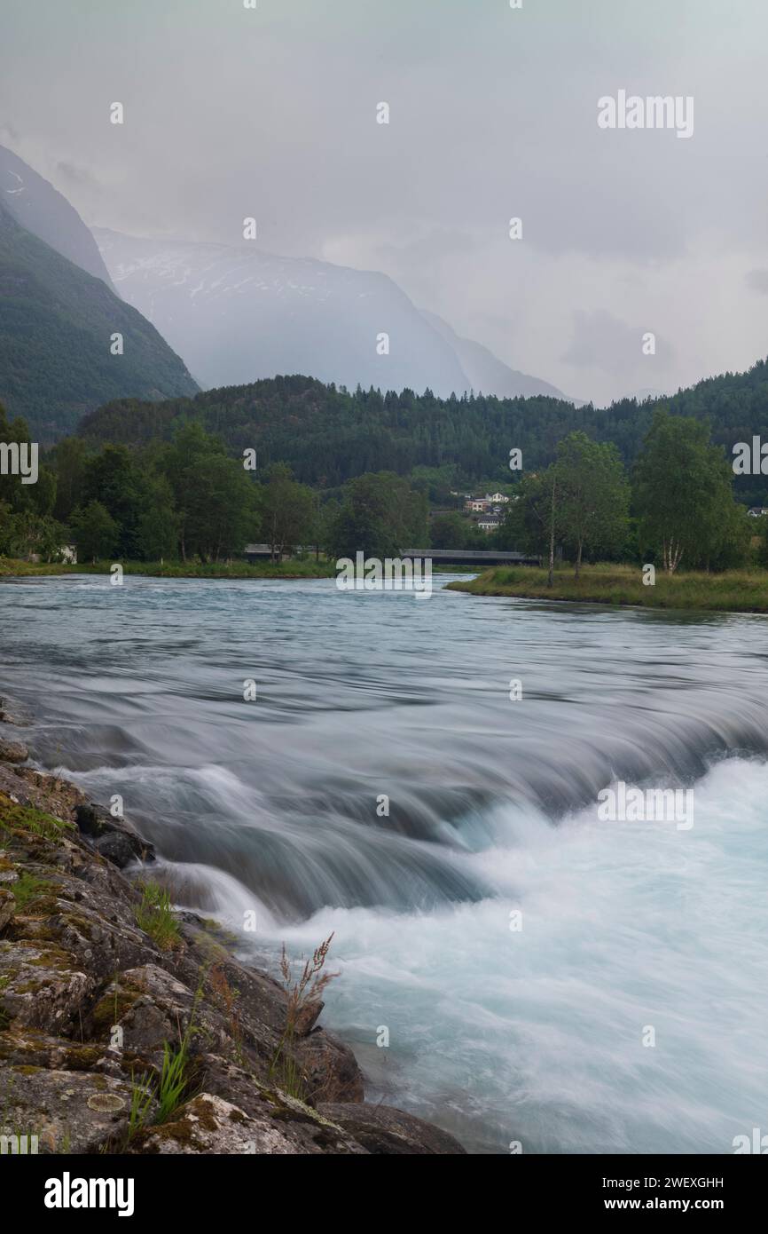 The Loelva River flows through the village of Loen, Norway during an ...