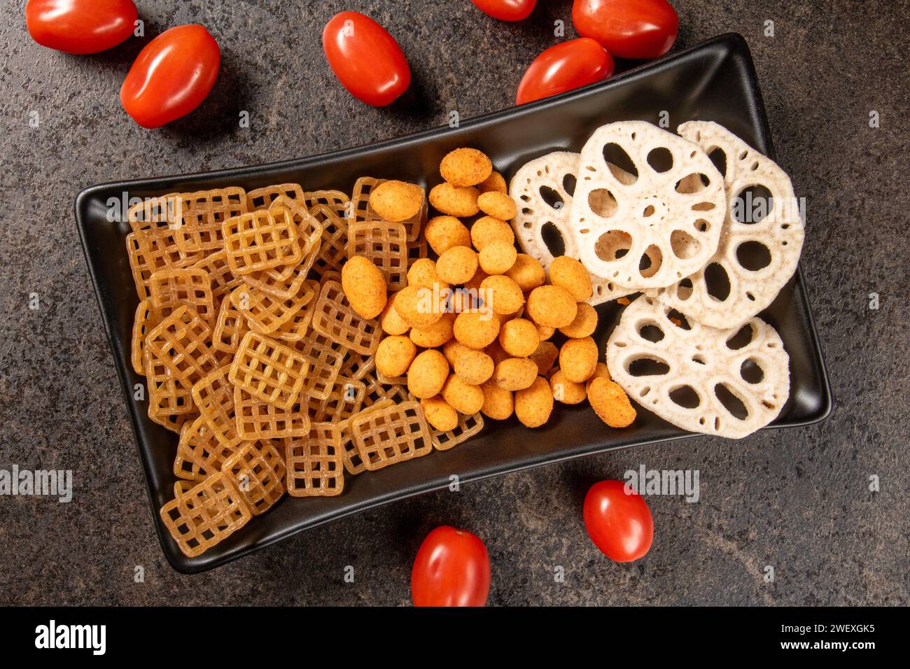 An assortment of various snacks for beer arranged on a dark background ...