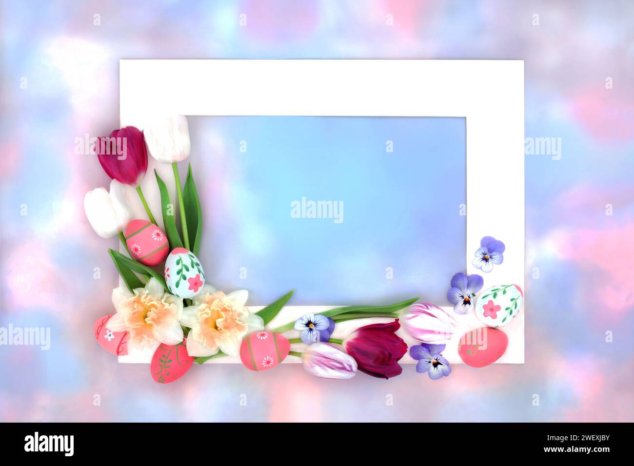 Easter background frame with eggs and spring flowers on pastel blue and ...