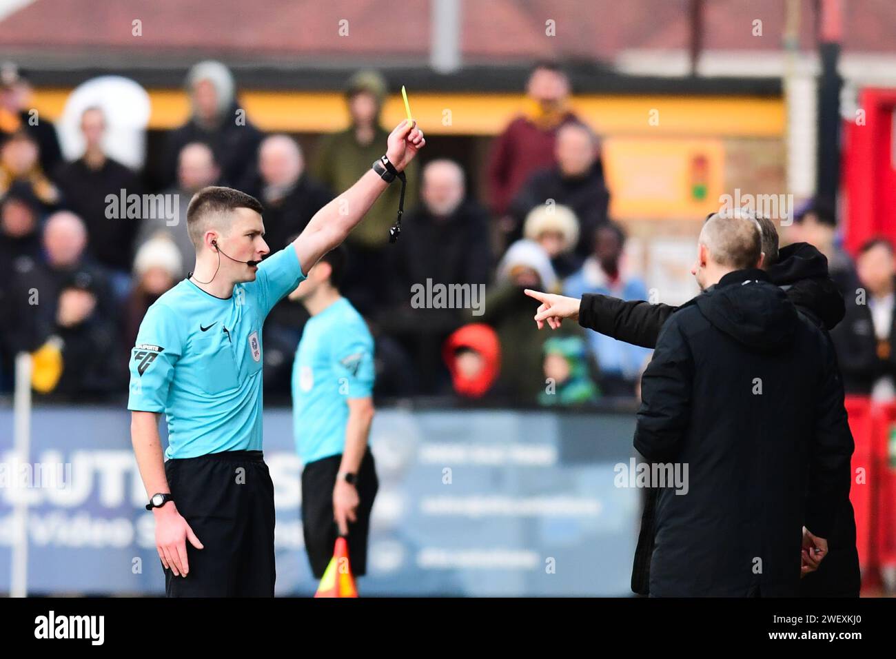 Referee Ed Duckworth (Match referee) shows yellow card to Manager Neil ...