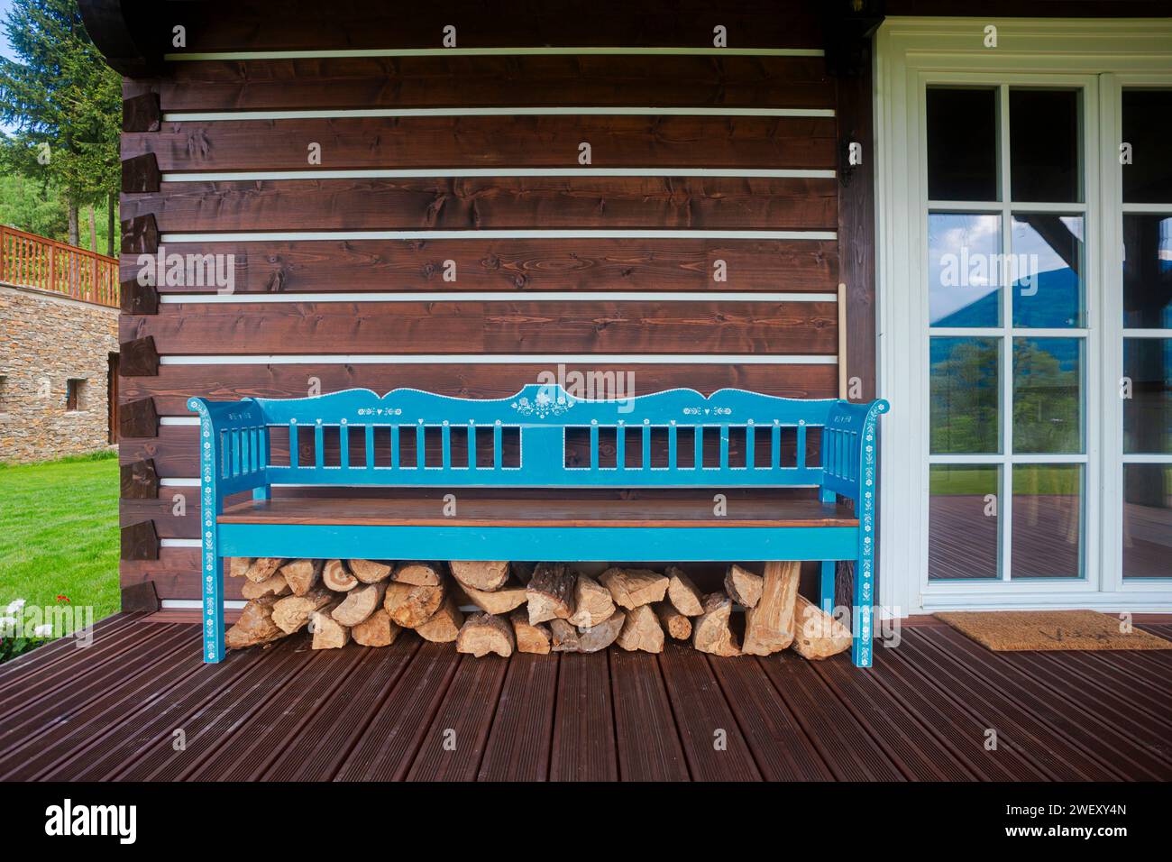 Bench, chairs and table on the terrace of the wooden house Stock Photo ...