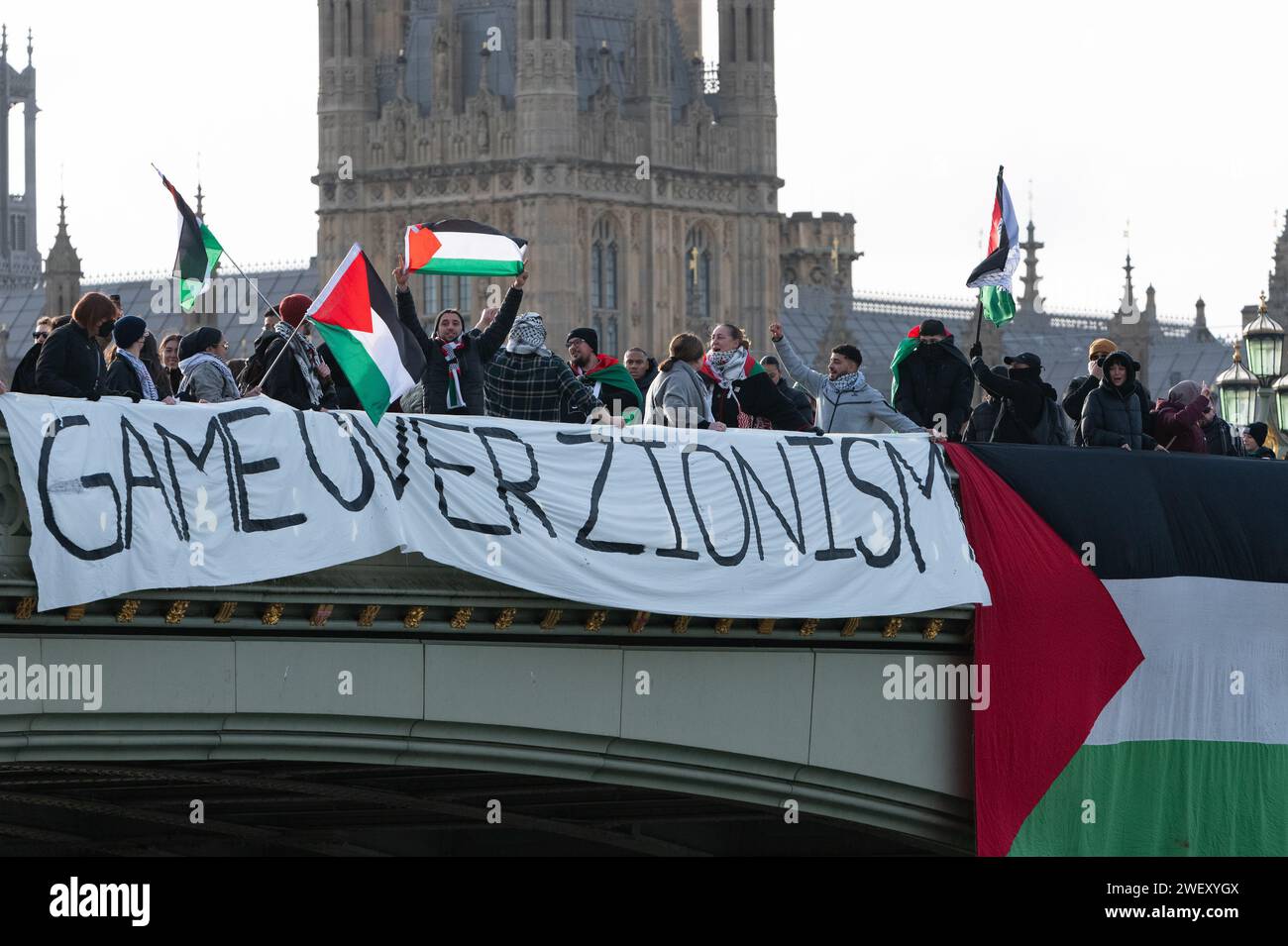 London, UK. 27 January, 2024. Palestine supporters drape a large ...