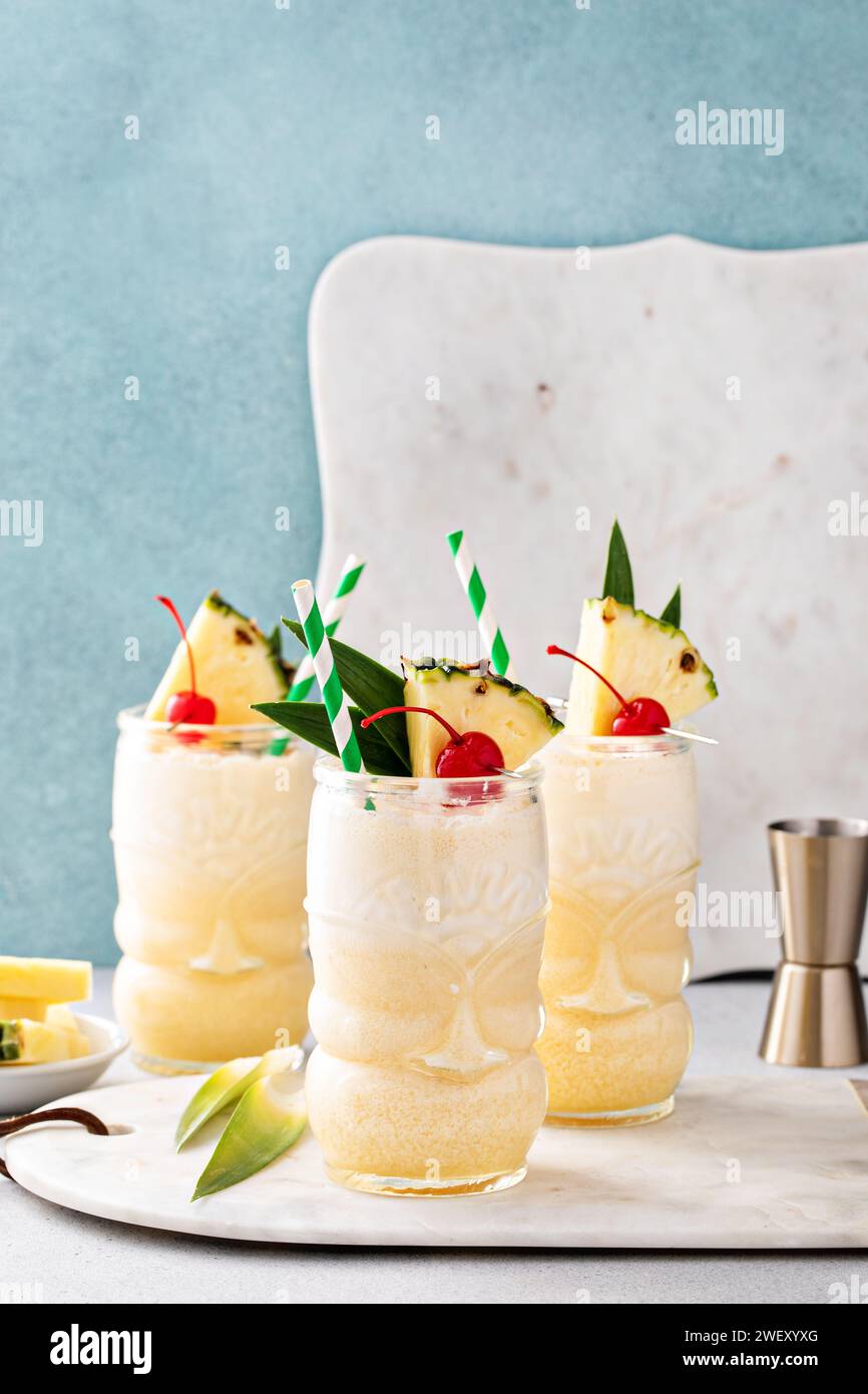 Tropical tiki cocktail pina colada in a fun glass garnished with ...