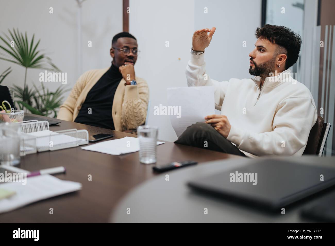 Male person explaining something during meeting in modern boardroom. He ...