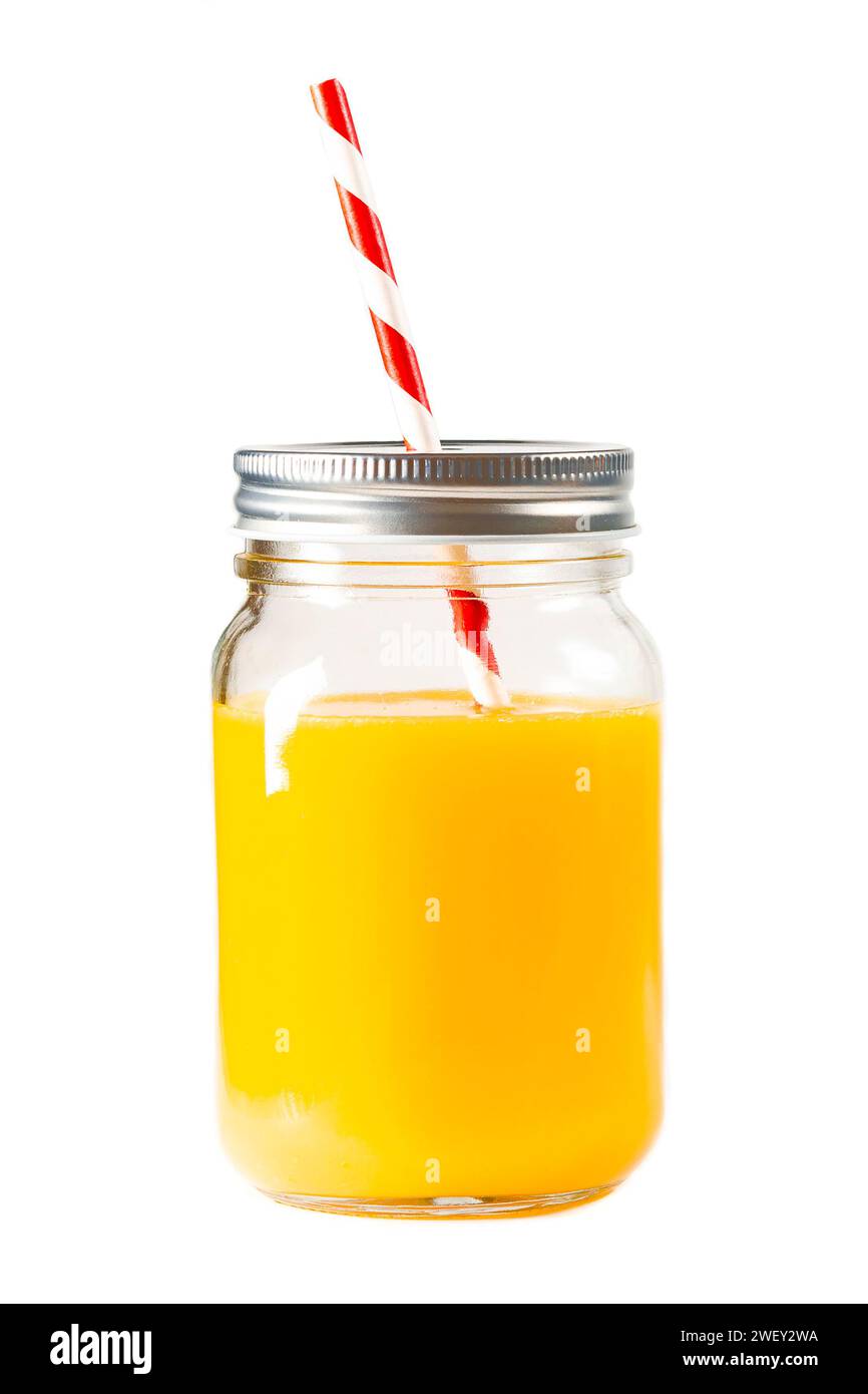 Fresh orange juice. A Glass jar of orange juice with a multi-colored ...